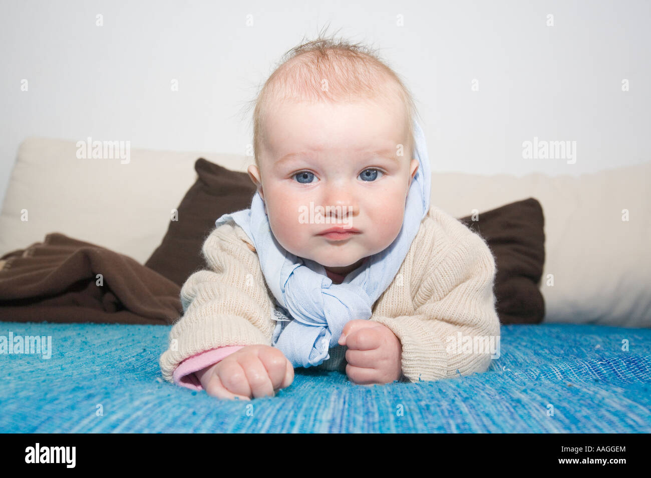 Baby Lying on Sofa Stock Photo - Alamy