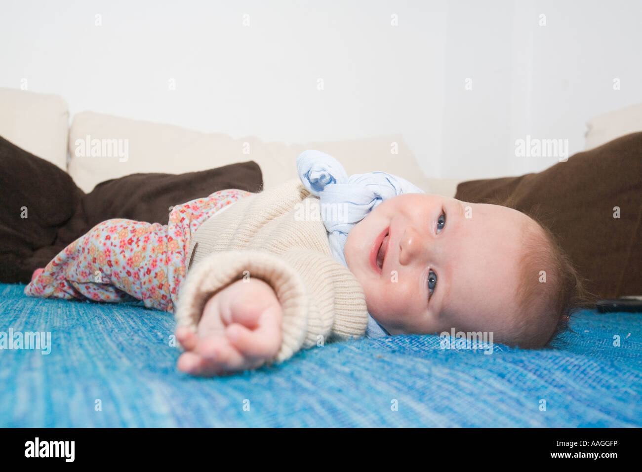 Baby Lying on Sofa Stock Photo - Alamy