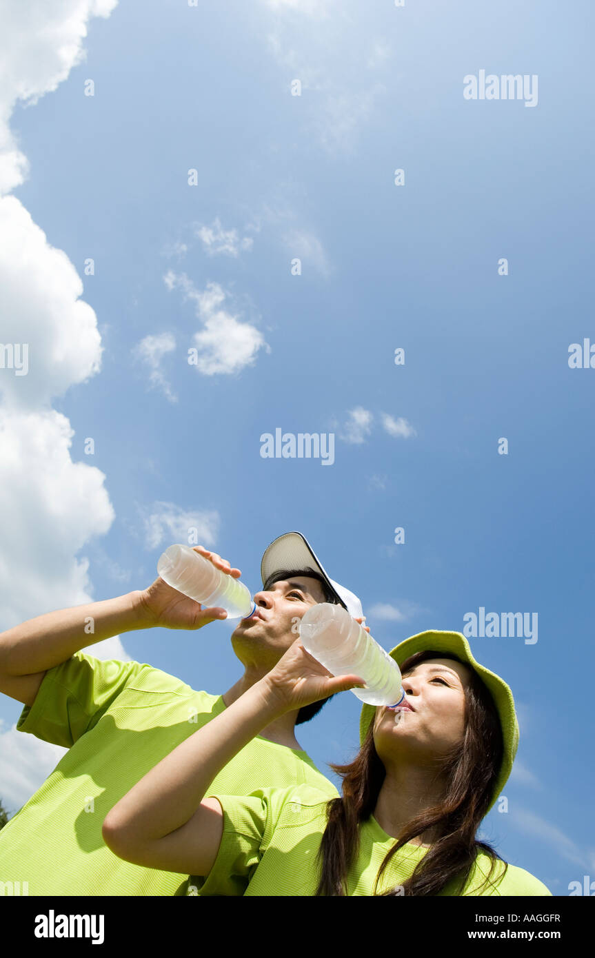 Husband and wife drinking water Stock Photo - Alamy