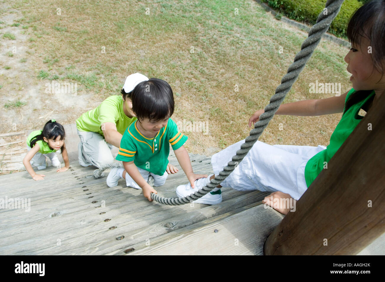 Family playing in playground Stock Photo - Alamy