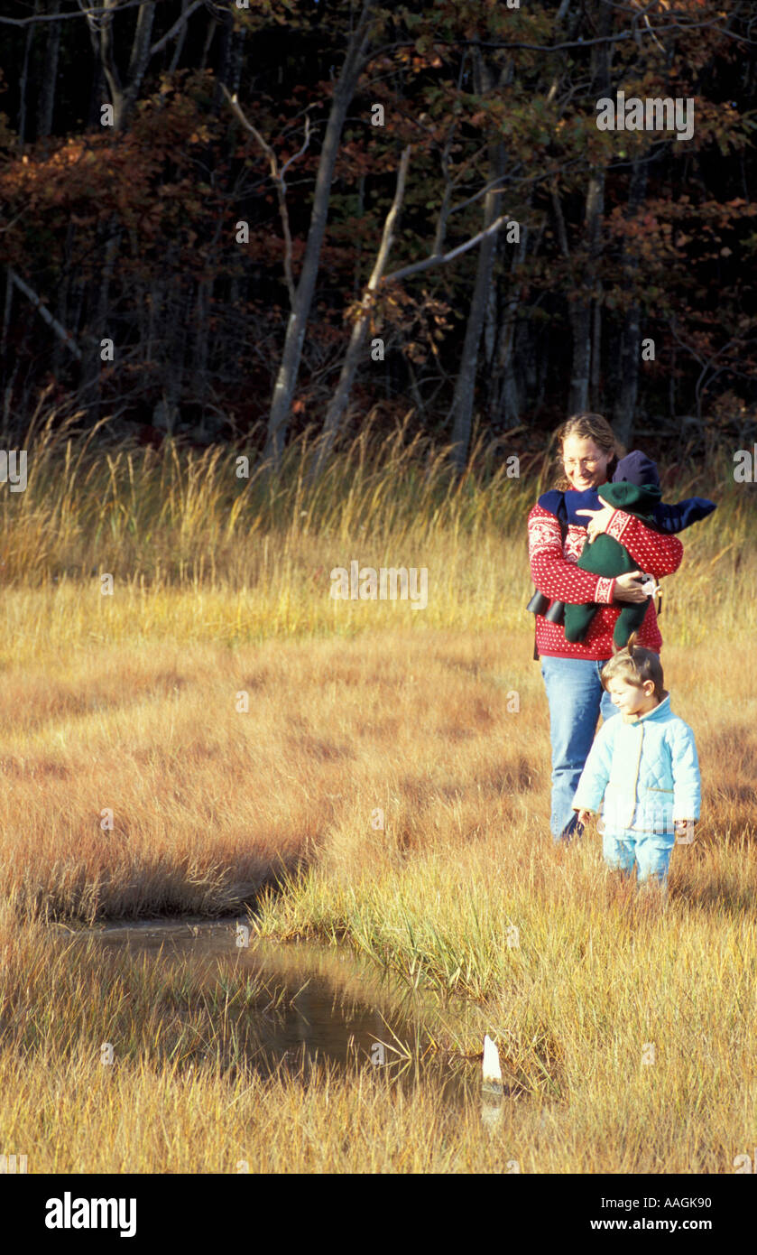 Biddeford ME A mother and her young children explore a salt marsh near ...