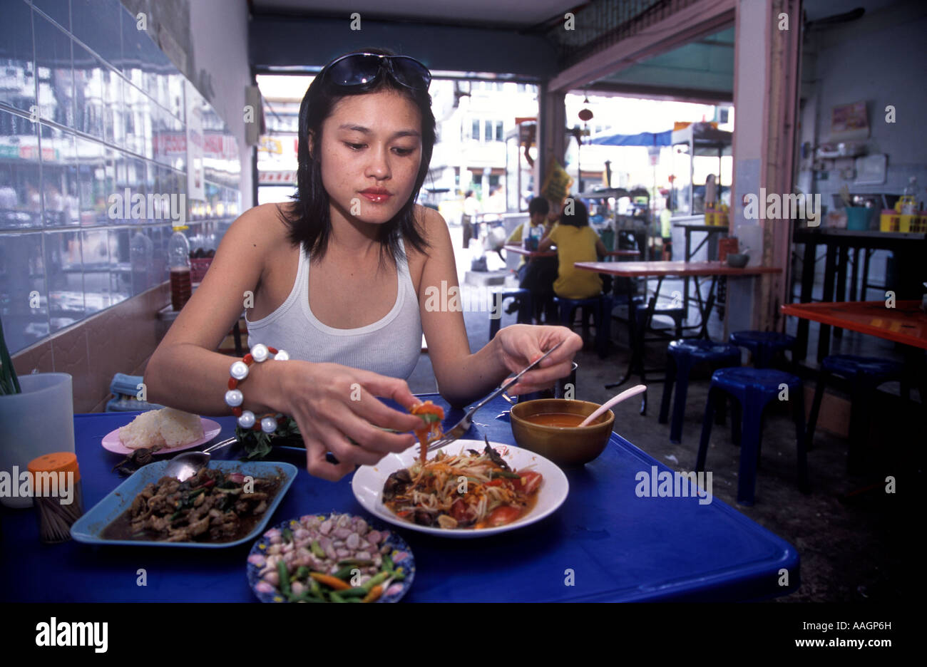 Eating Thai food at a typical open style restaurant in Bangkok ...