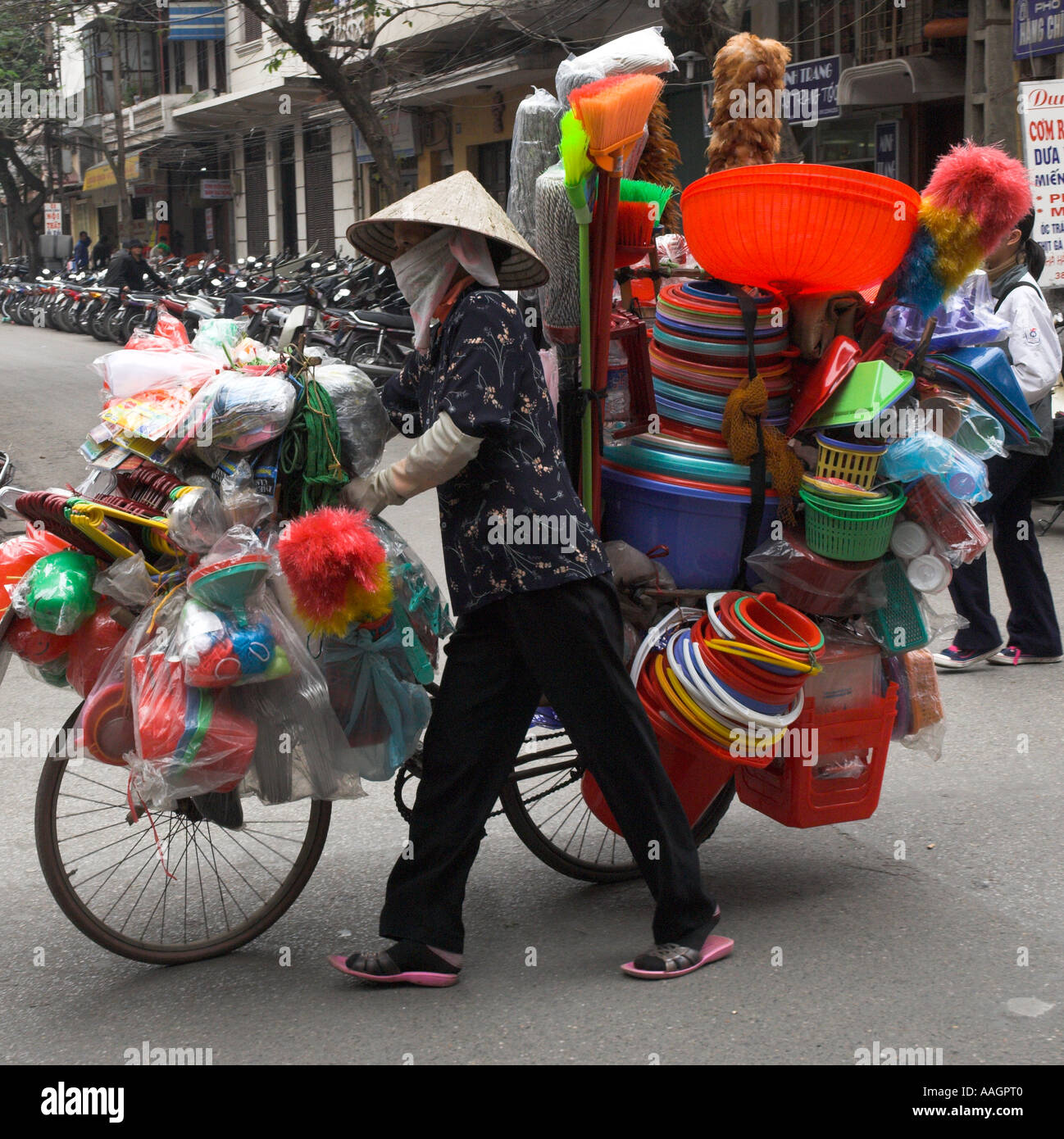 Vietnam Hanoi Female street merchant pushing her bike loaded with house ...