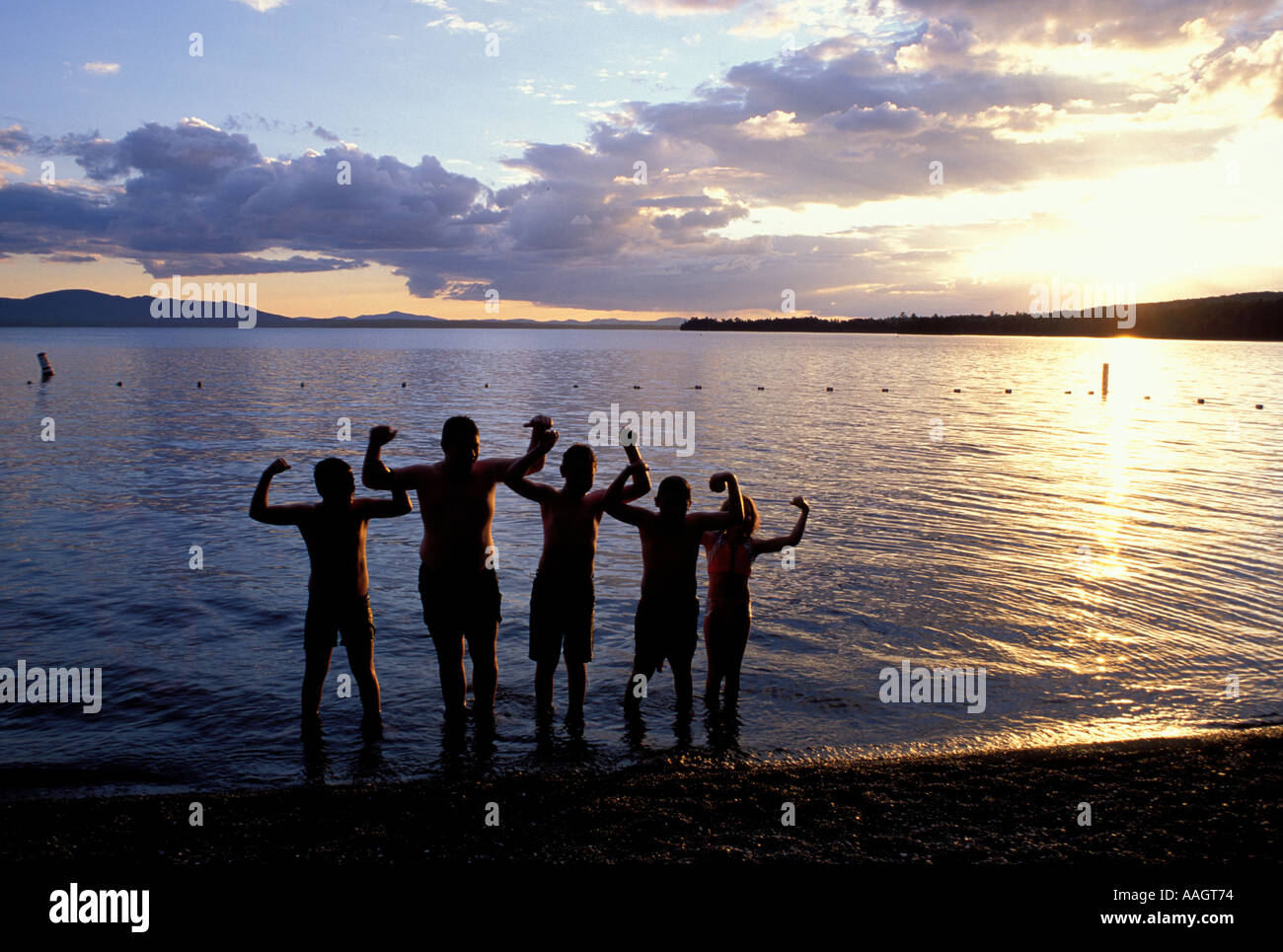 Young swimmers flexing biceps in Lily Bay Stock Photo - Alamy