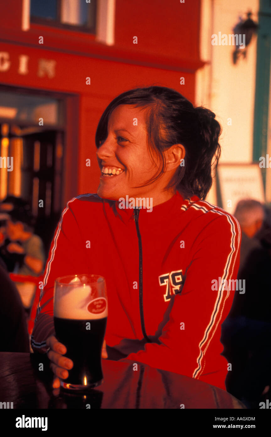 Young woman drinking Guinness outside a pub on quai Baltimore County ...