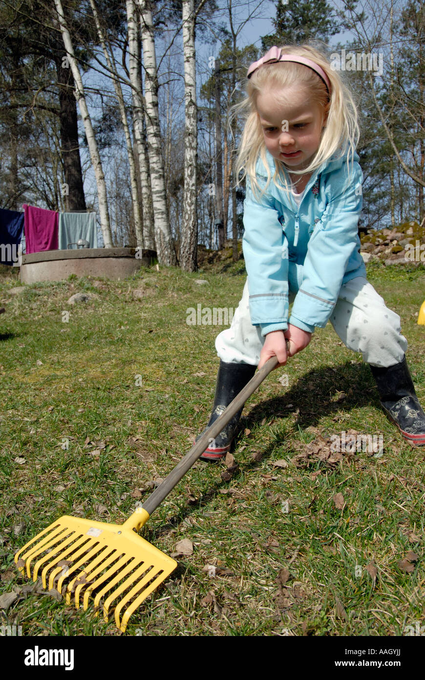 Little girl raking hi-res stock photography and images - Alamy