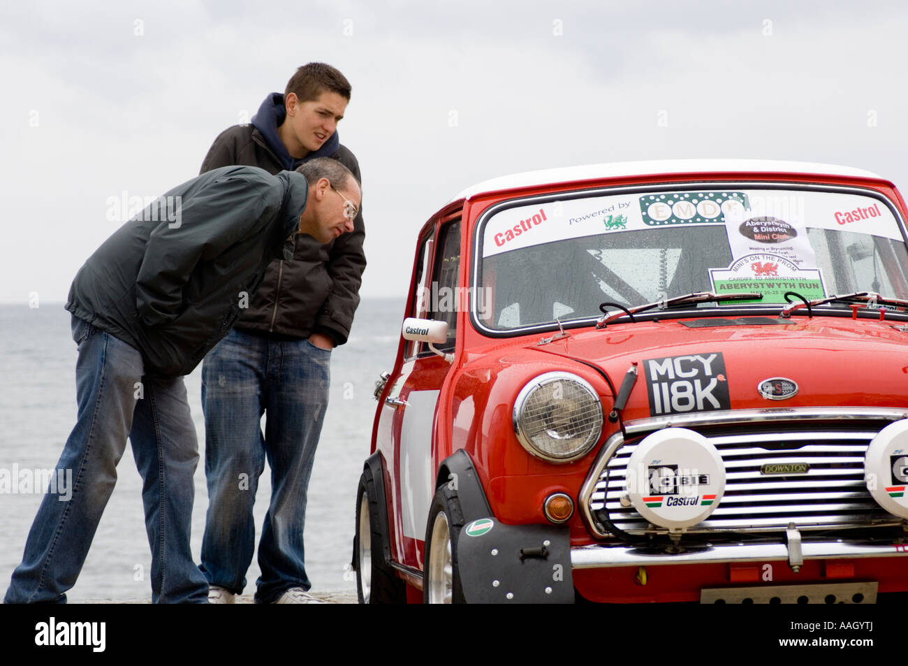 two men admiring a classic english car at a mini car owners rally ...