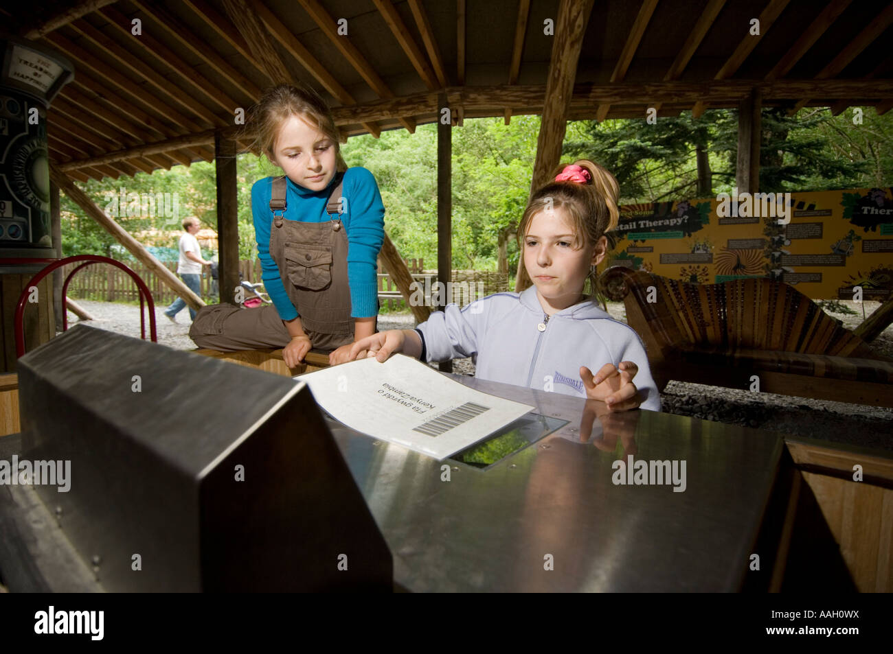 Children scanning information on the environmental cost of various ...