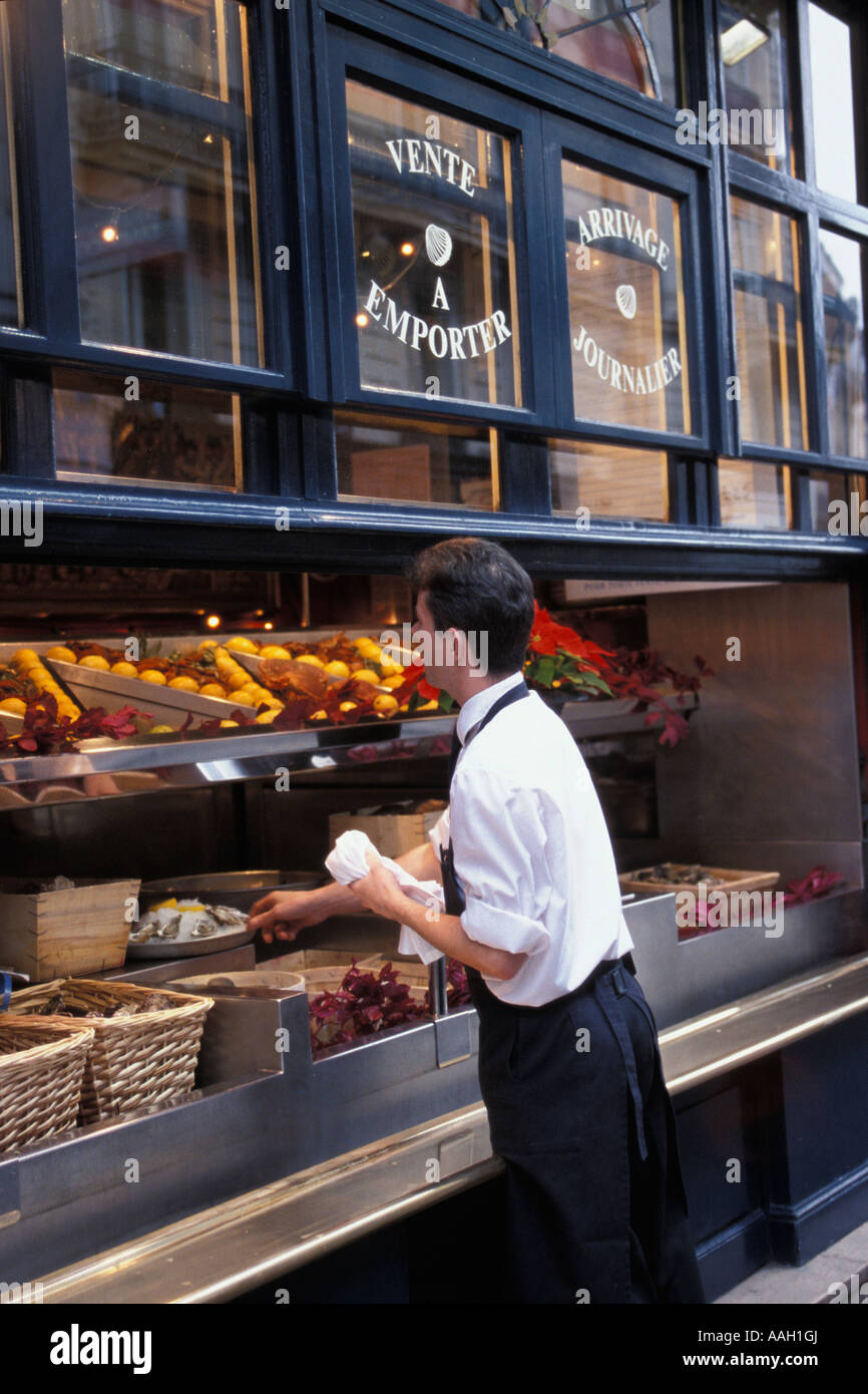Waiter arranging a shop window in a Paris Bistro Paris France Stock ...