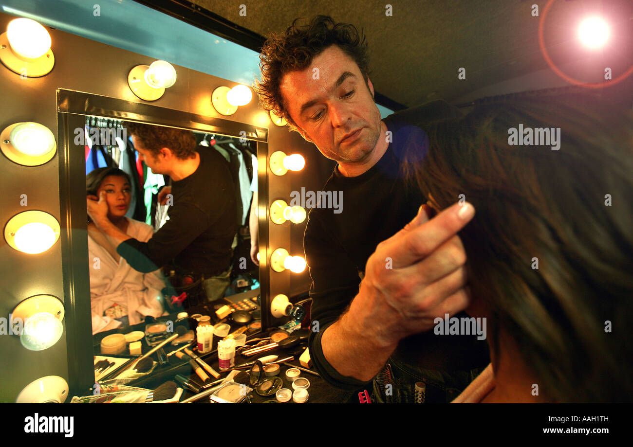 A cosmetician applying make up on models and actors editorial use only ...