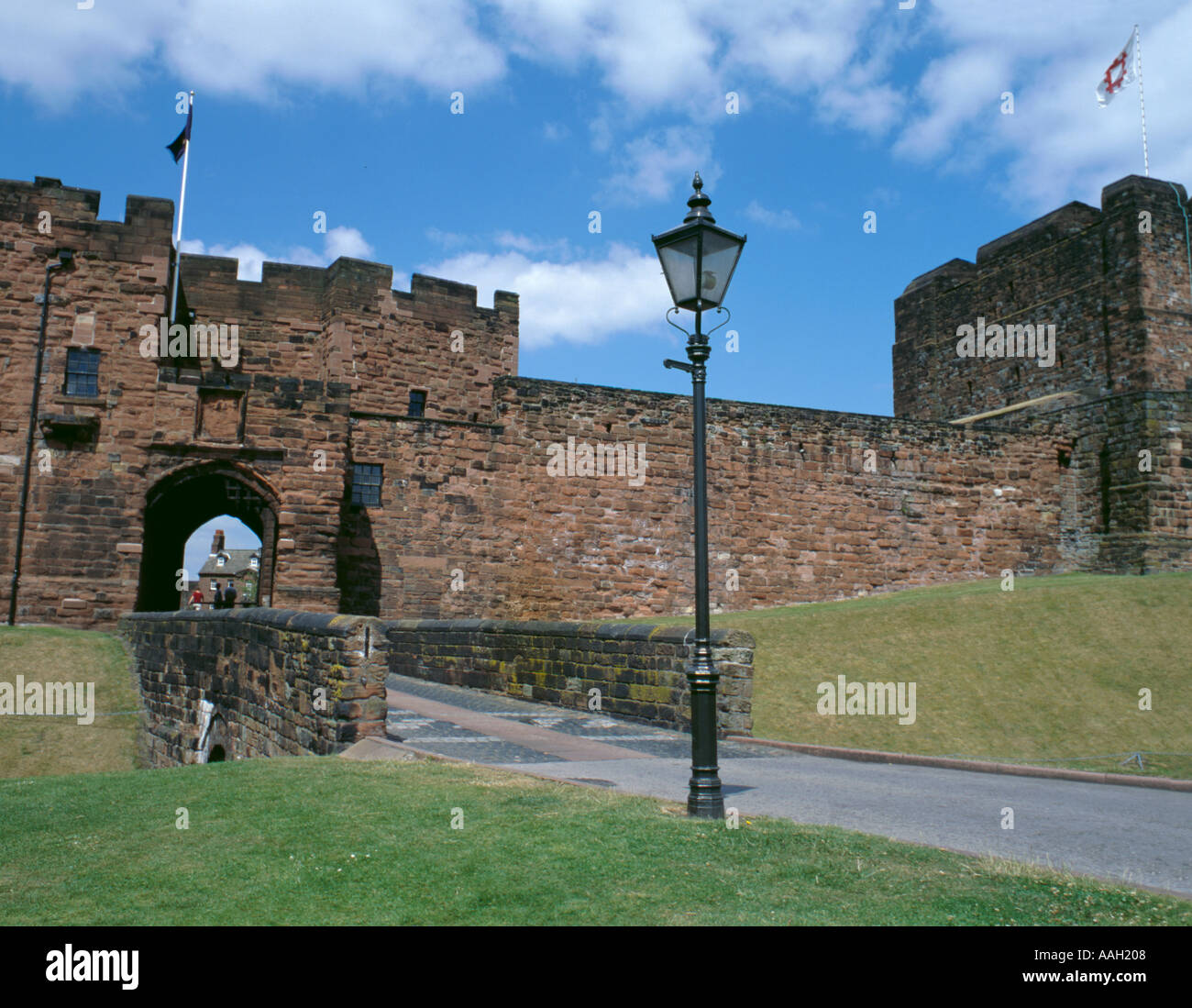 Red sandstone outer gatehouse, walls and Norman keep of Carlisle Castle ...