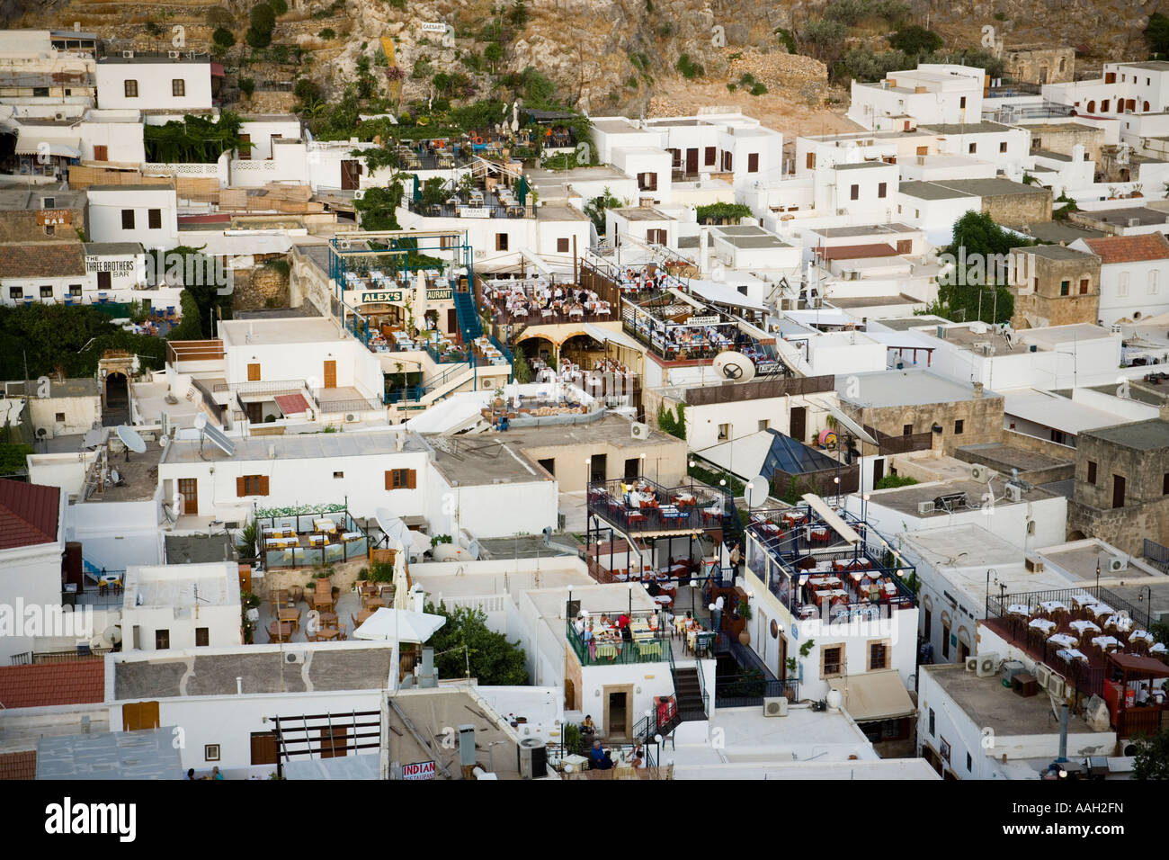 View over town in the evening people sitting on terraces of restaurants ...