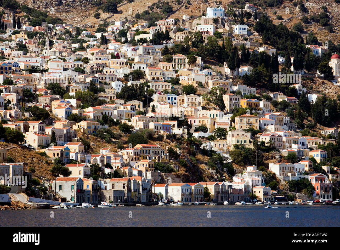 View from Aegean Sea to a sea of houses at mountainside Symi Simi ...