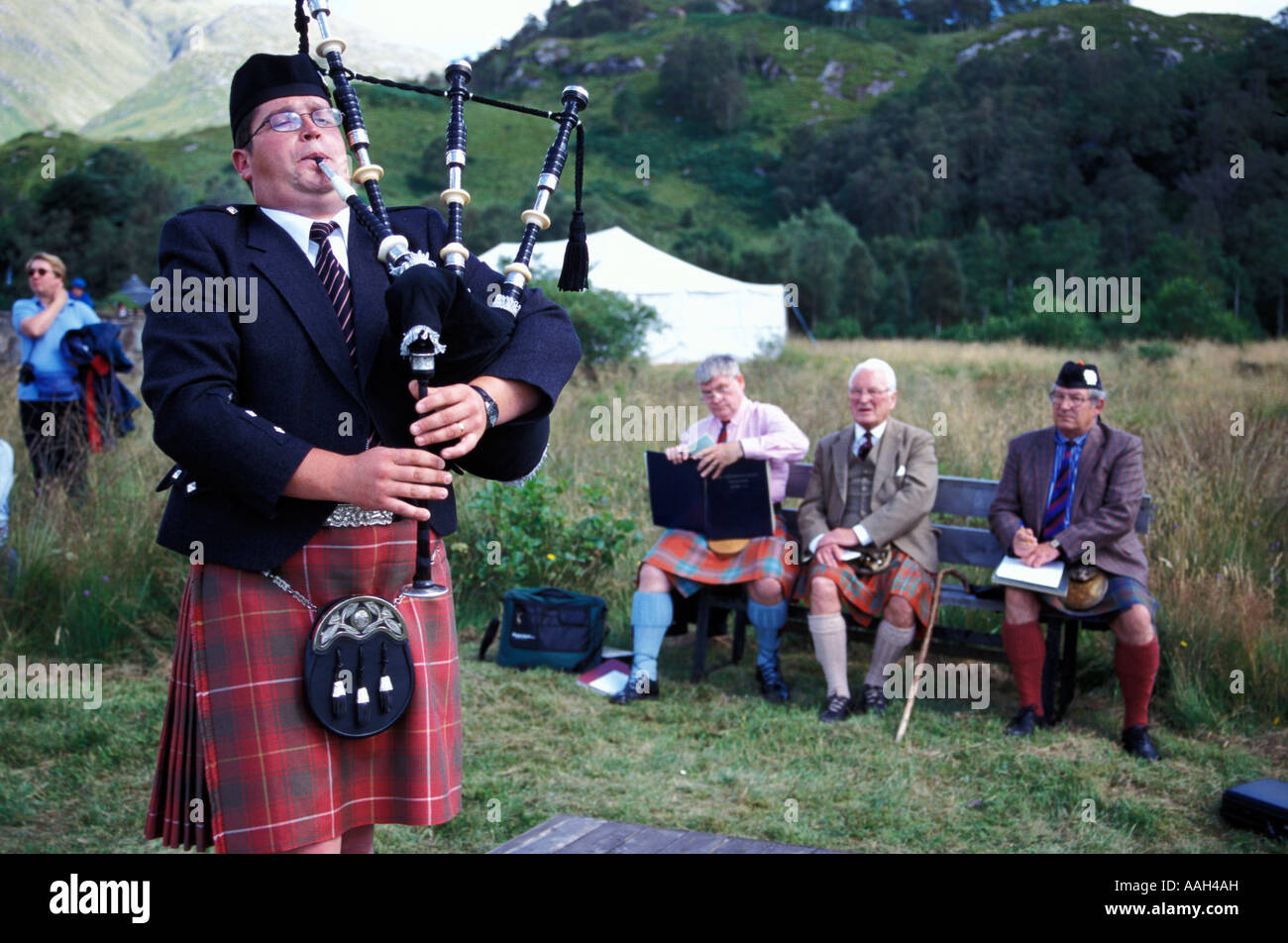 Judges on a bench watching a piper Glenfinnan Highland Games Inverness ...