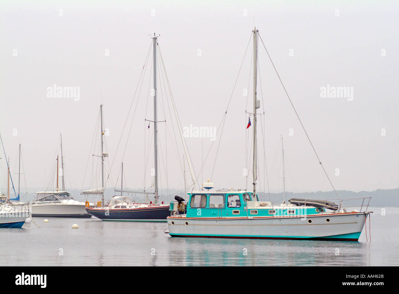 Sailboats in mist Stock Photo - Alamy