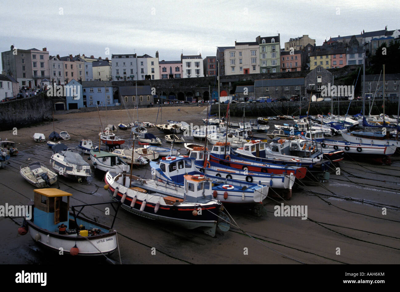 Low tide boats in harbour Tenby Pembrokeshire National Park Dyfed Wales ...