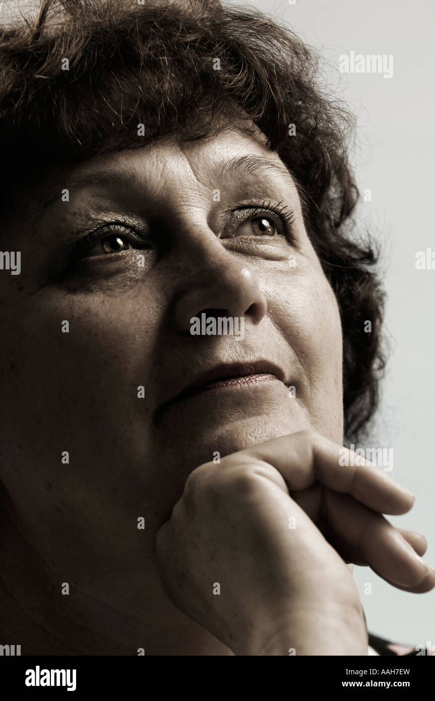 Sixty years old woman with thoughtful daydreaming expression Stock ...