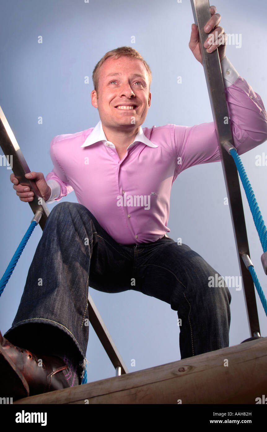 BUSINESSMAN EDWARD WEBB OF PLAYFORCE ON A ROPE BRIDGE IN A PLAYGROUND ...