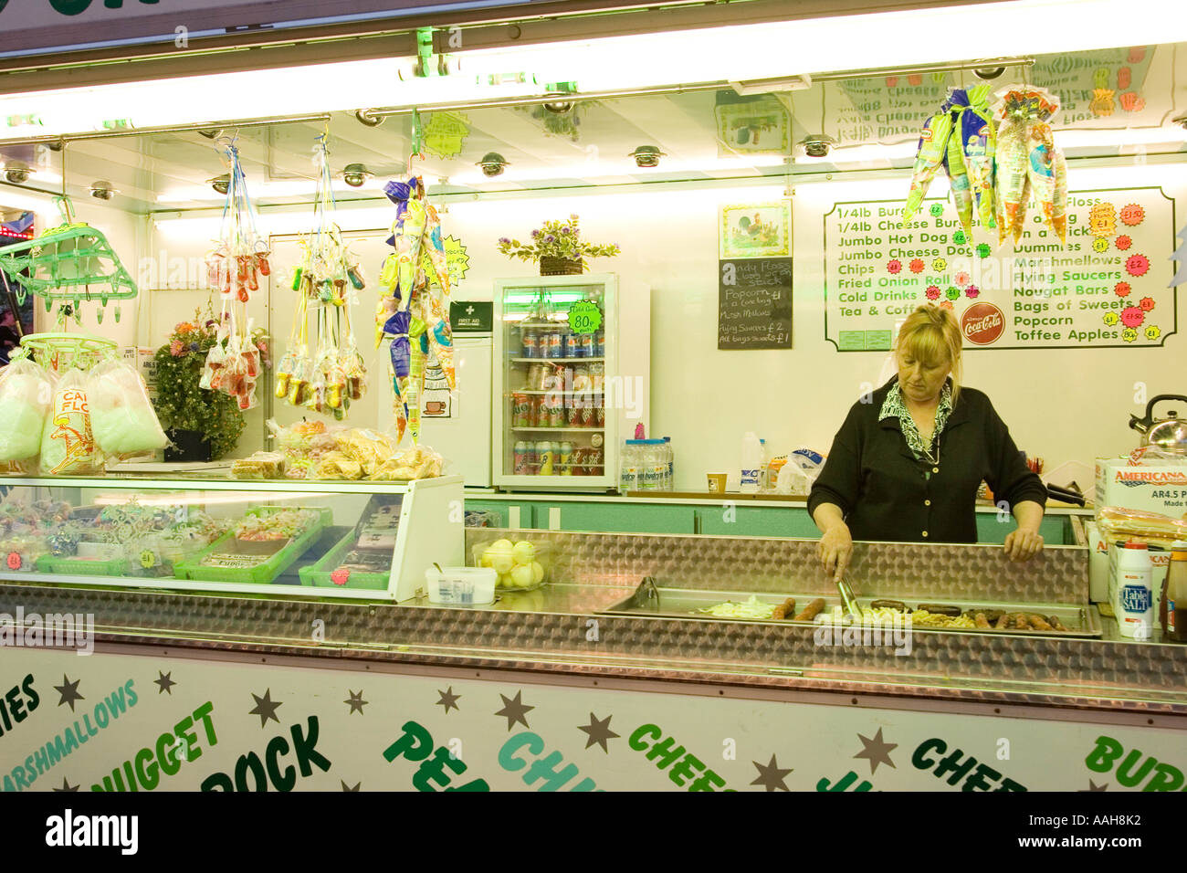 A woman preparing food on a stall at the funfair at Bardwell in Suffolk ...