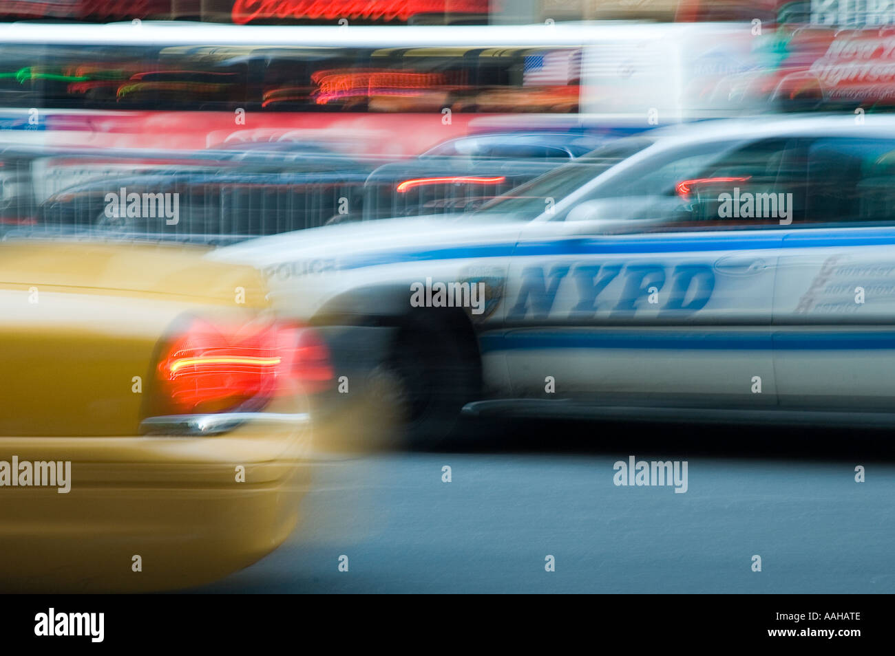 NYPD cruiser and yellow taxi cab in motion in New York City Stock Photo ...