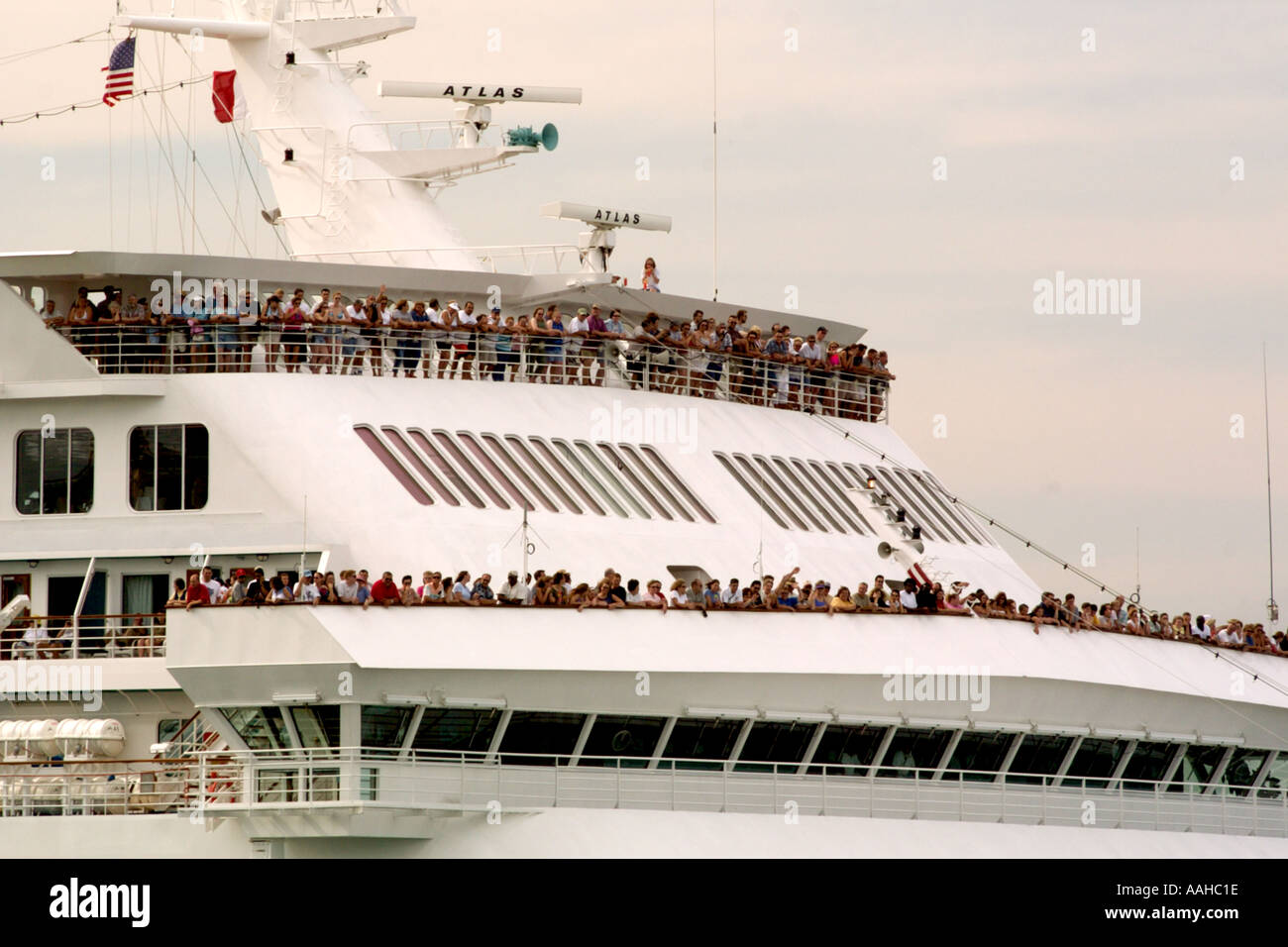 Cruise ship passengers along rails during departure for Caribbean ...