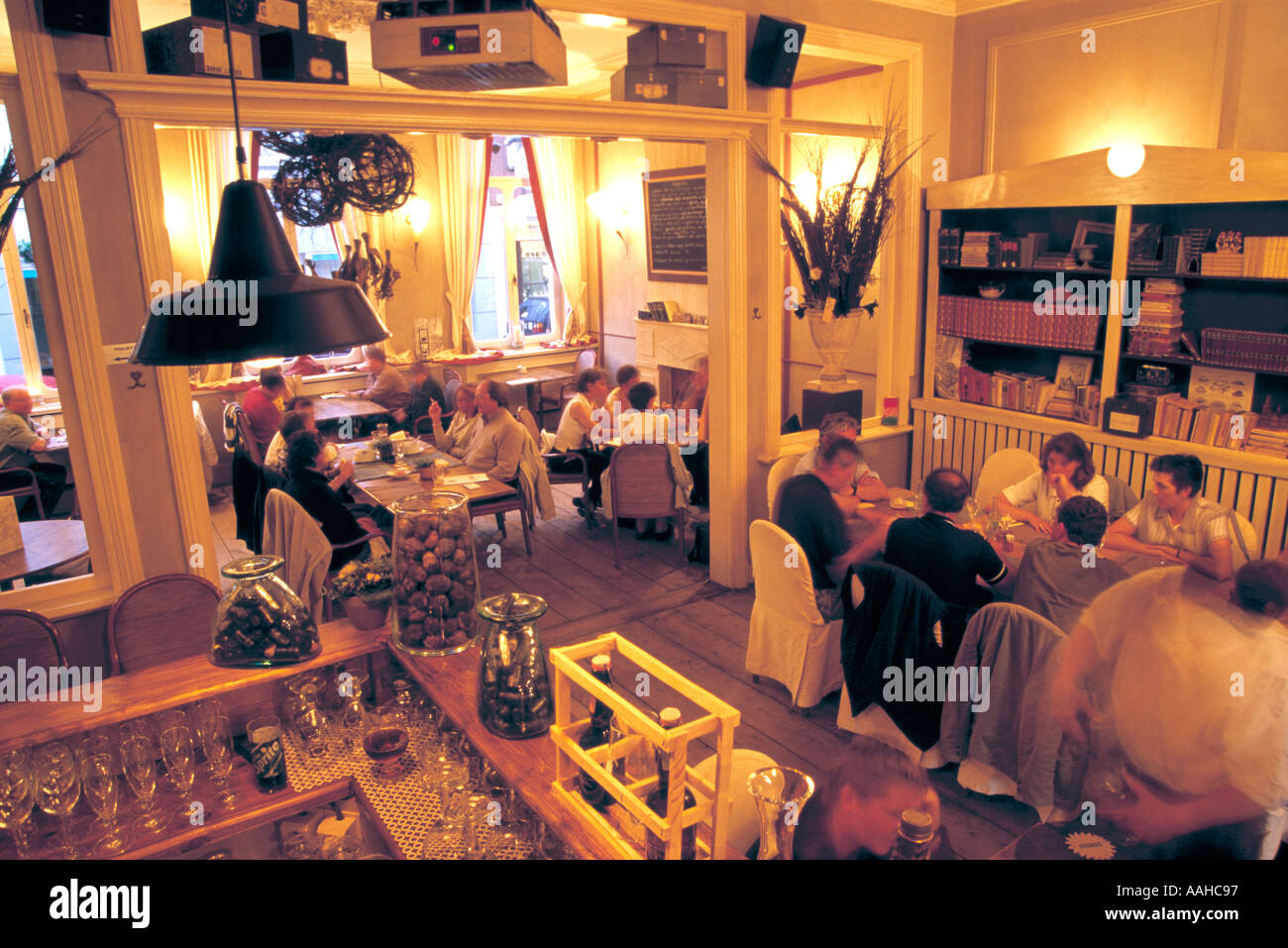restaurant interior yellow cosy crowd group people eat eating brasserie ...