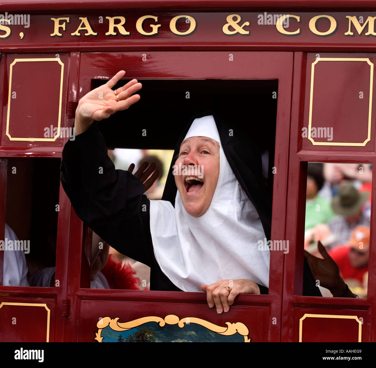 Nun in a stage coach waving Stock Photo - Alamy