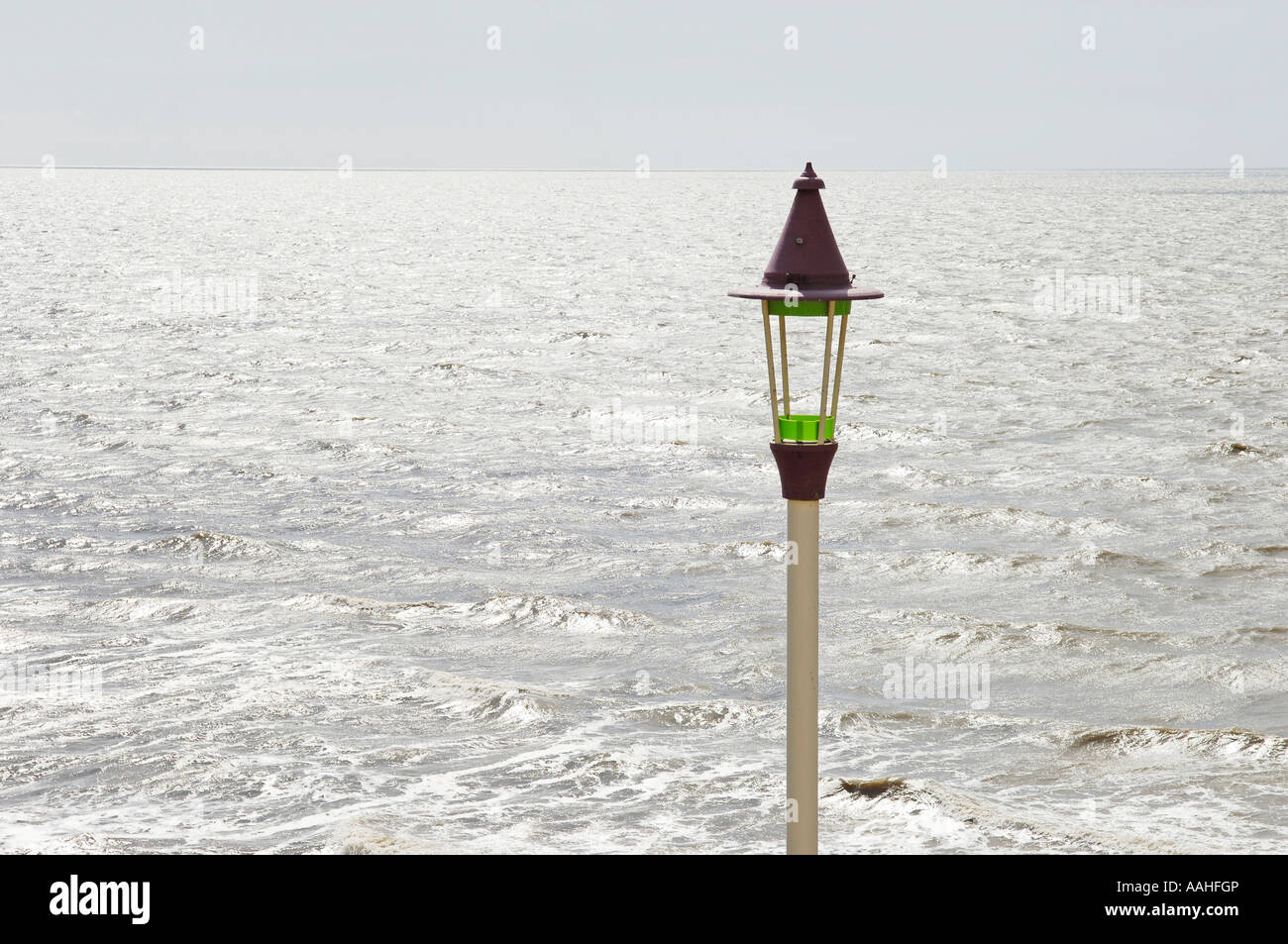 Lamp post set against sea Stock Photo - Alamy