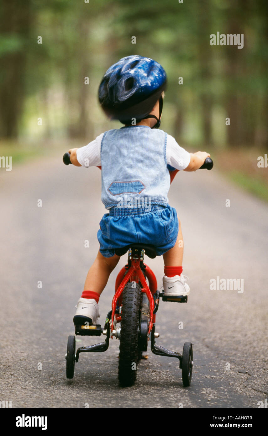 Child riding bicycle rear view Stock Photo - Alamy
