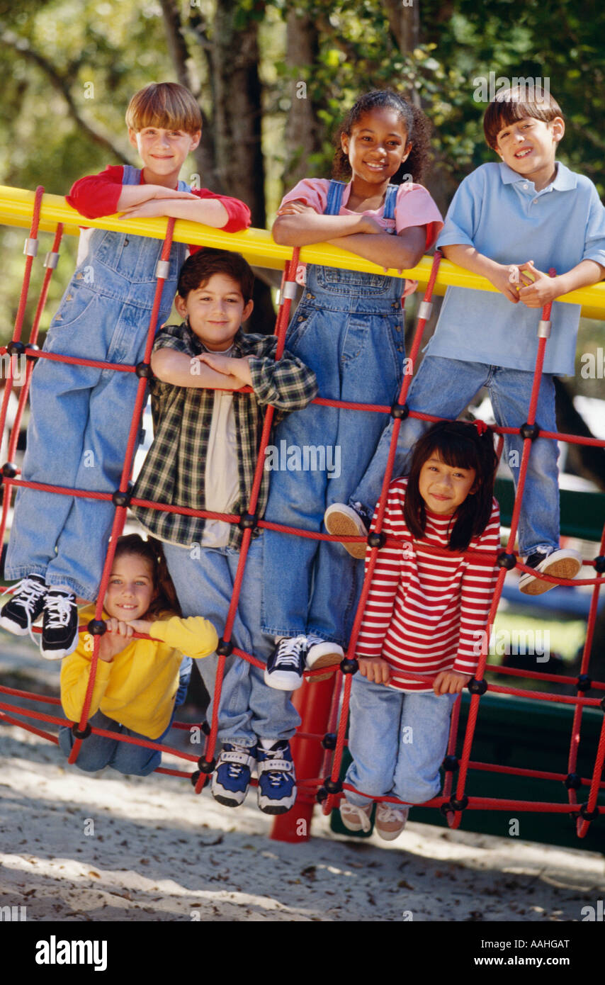 Children 6 9 standing by railing portrait Stock Photo - Alamy
