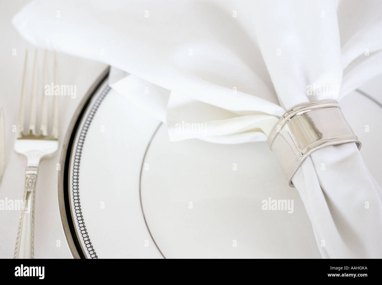 Fine china place setting with silverware Stock Photo - Alamy