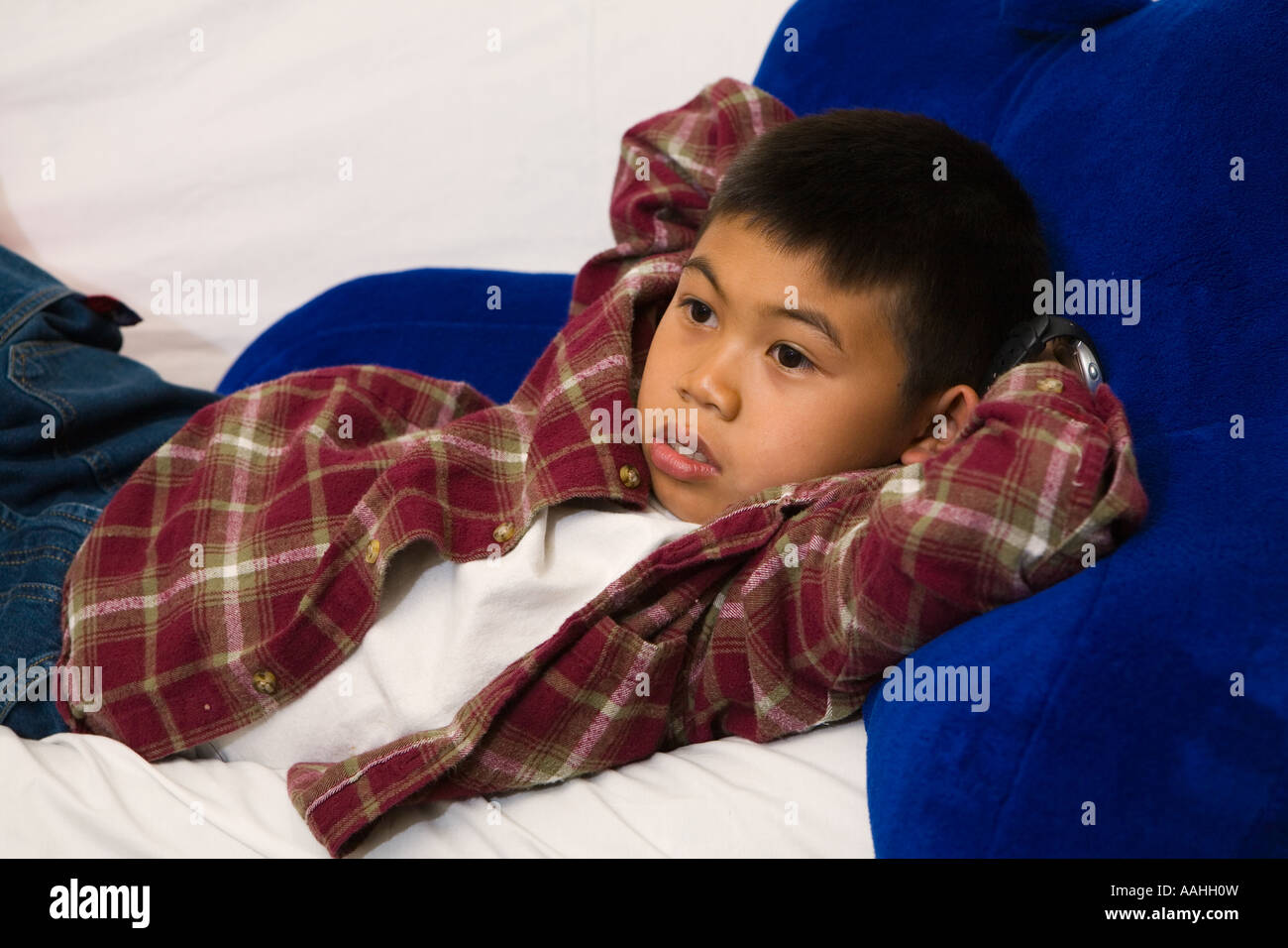 Sprawled out on the sofa Stock Photo - Alamy