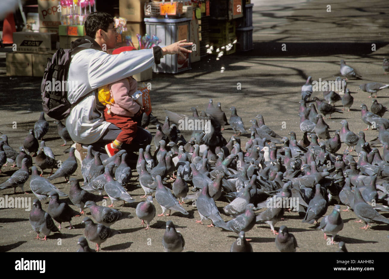 Japan Tokyo Ueno park Feeding the pigeons parent child Stock Photo - Alamy