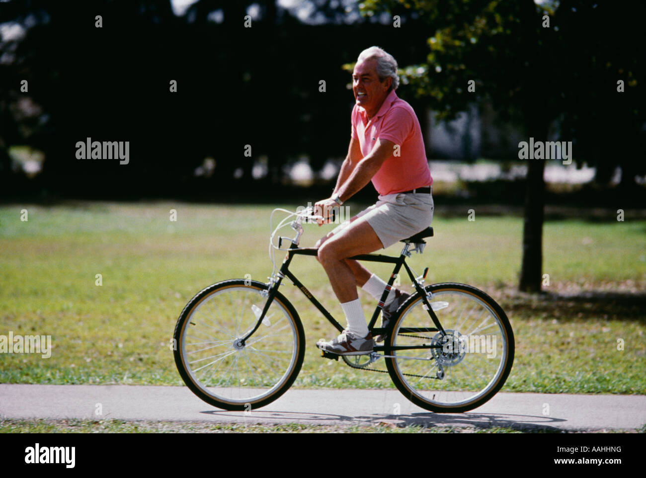 Senior man riding bicycle side view Stock Photo - Alamy