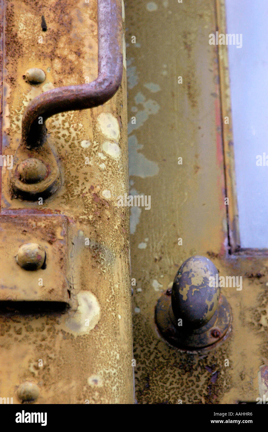 Antique Old, Rusted metal yellow door and handle on an old railroad ...