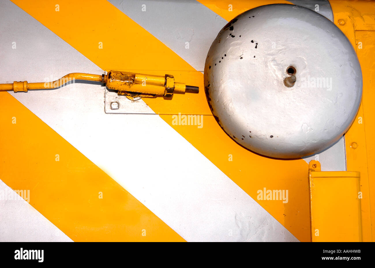An old silver metal bell on a yellow striped train engine door Stock ...