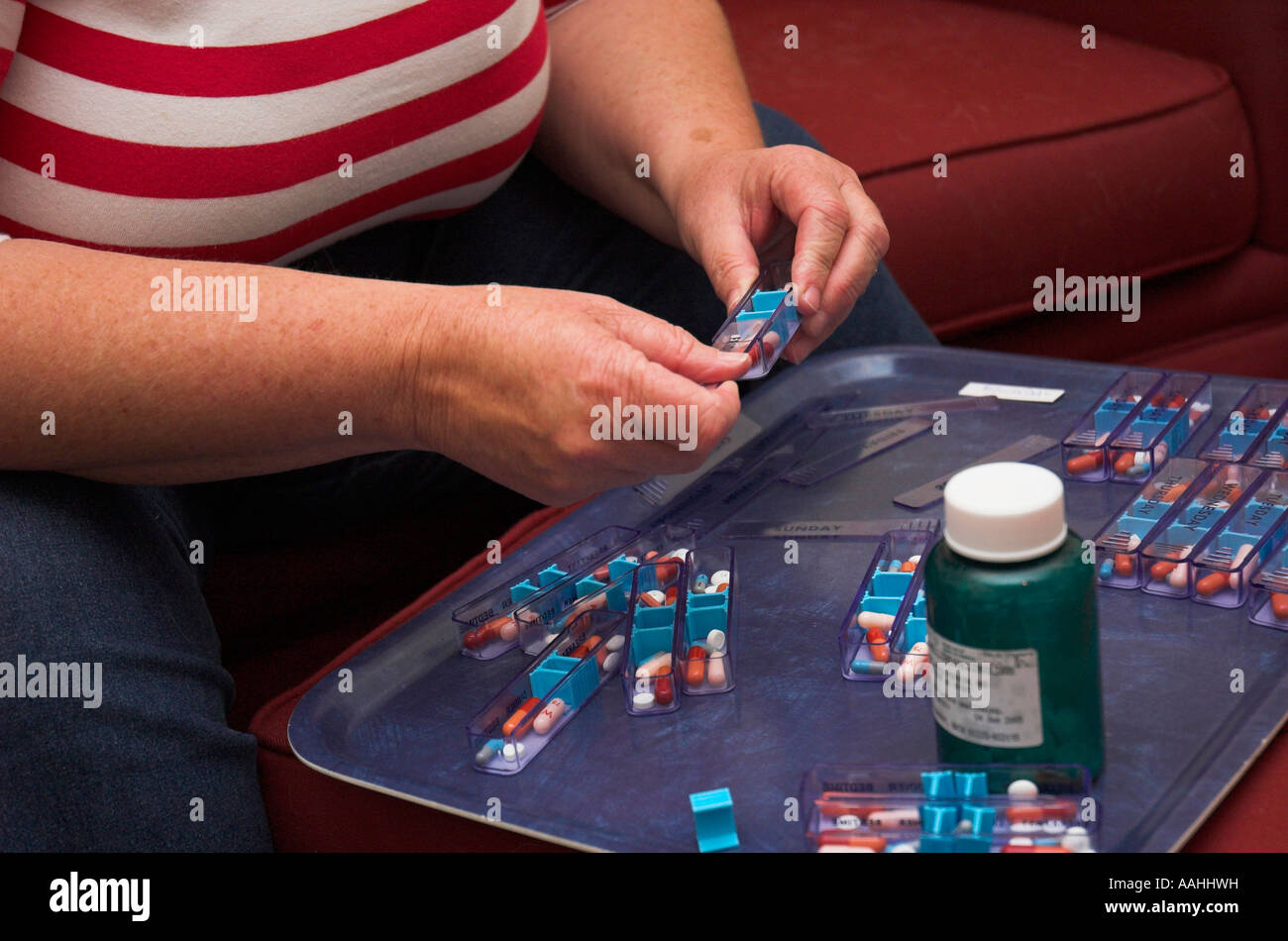 Woman preparing daily medication prescriptions in dose boxes Stock ...