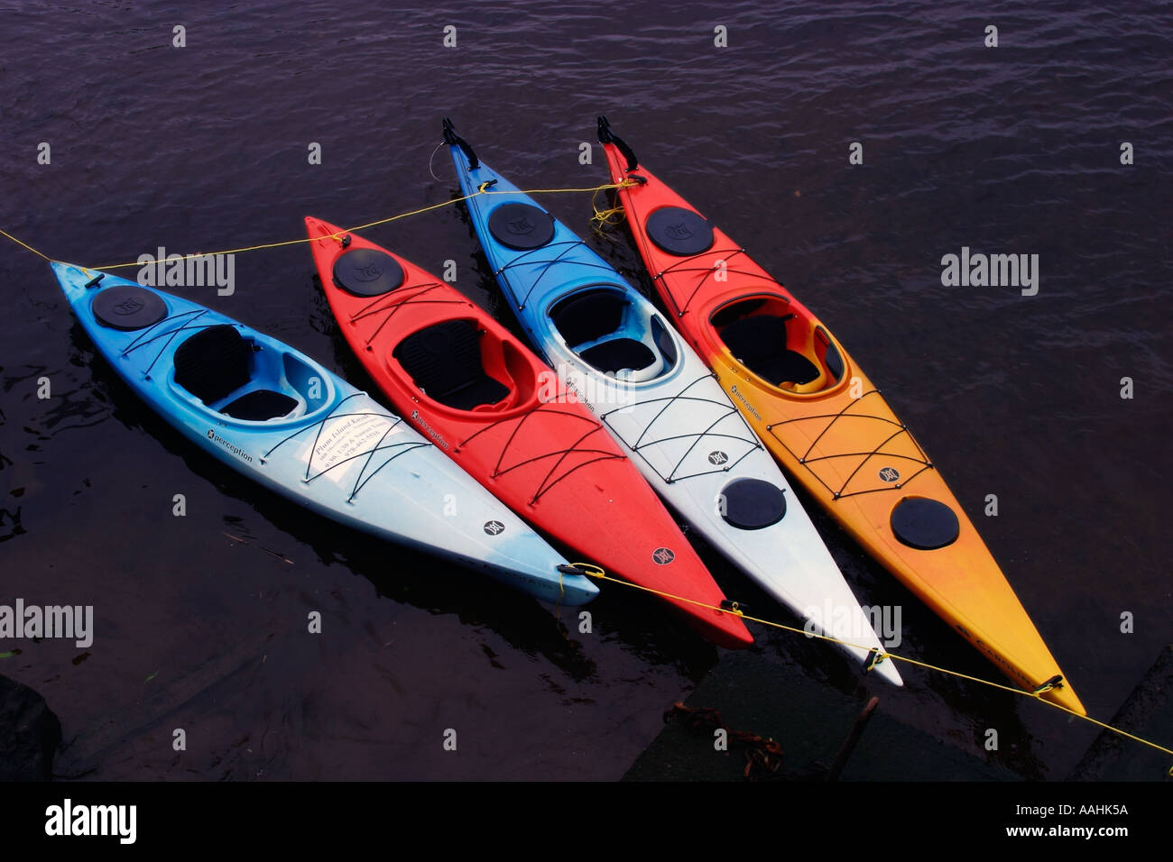 Colorful Kayaks tied together Stock Photo - Alamy