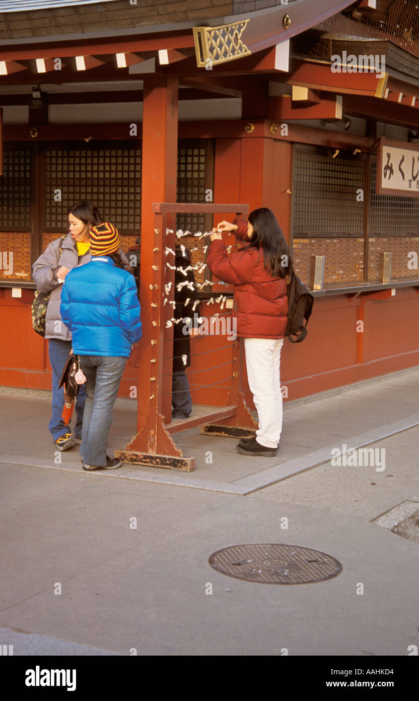 Japan Tokyo Asakusa Temple Tying bad fortune slips to a stand Stock ...