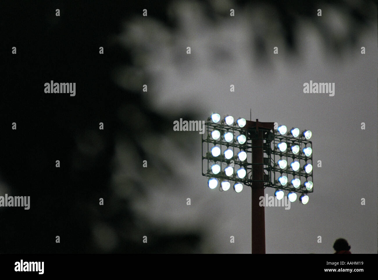 stadium floodlights lit at night with dramatic sky Stock Photo - Alamy