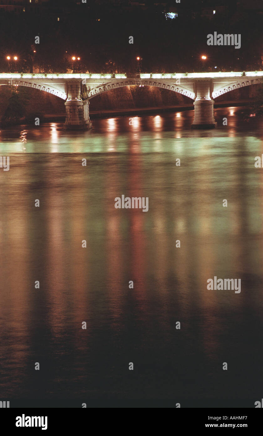 Lit bridge at night with reflections in river Stock Photo - Alamy