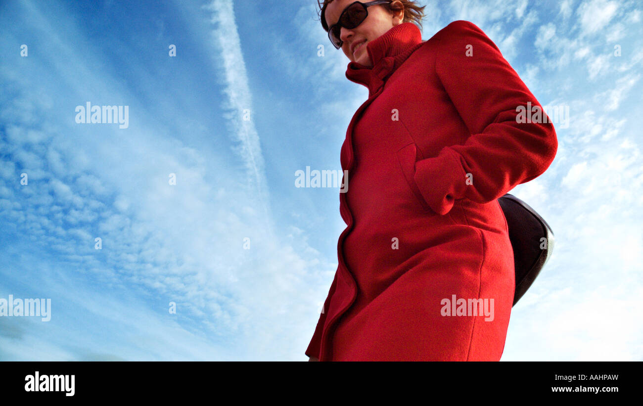 A lady wearing a red winter coat Stock Photo - Alamy