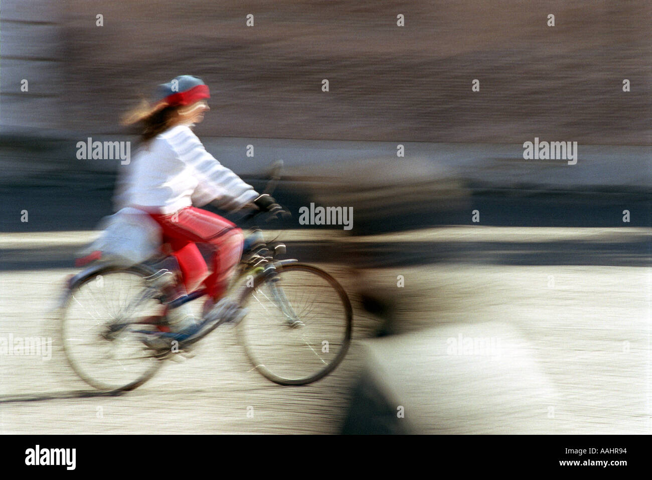 woman speeding by on bicycle movement Stock Photo - Alamy