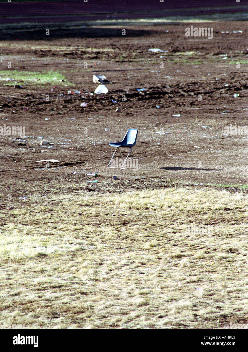 green plastic chair abandoned on derelict land Stock Photo - Alamy