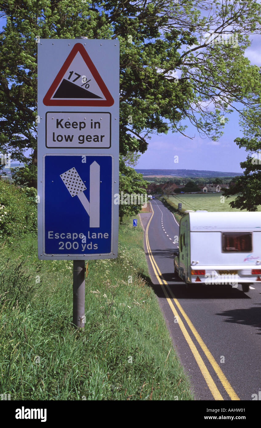 Vehicles Passing Warning Sign Of Steep Hill Ahead And Emergency Stopping Lane For Runaway