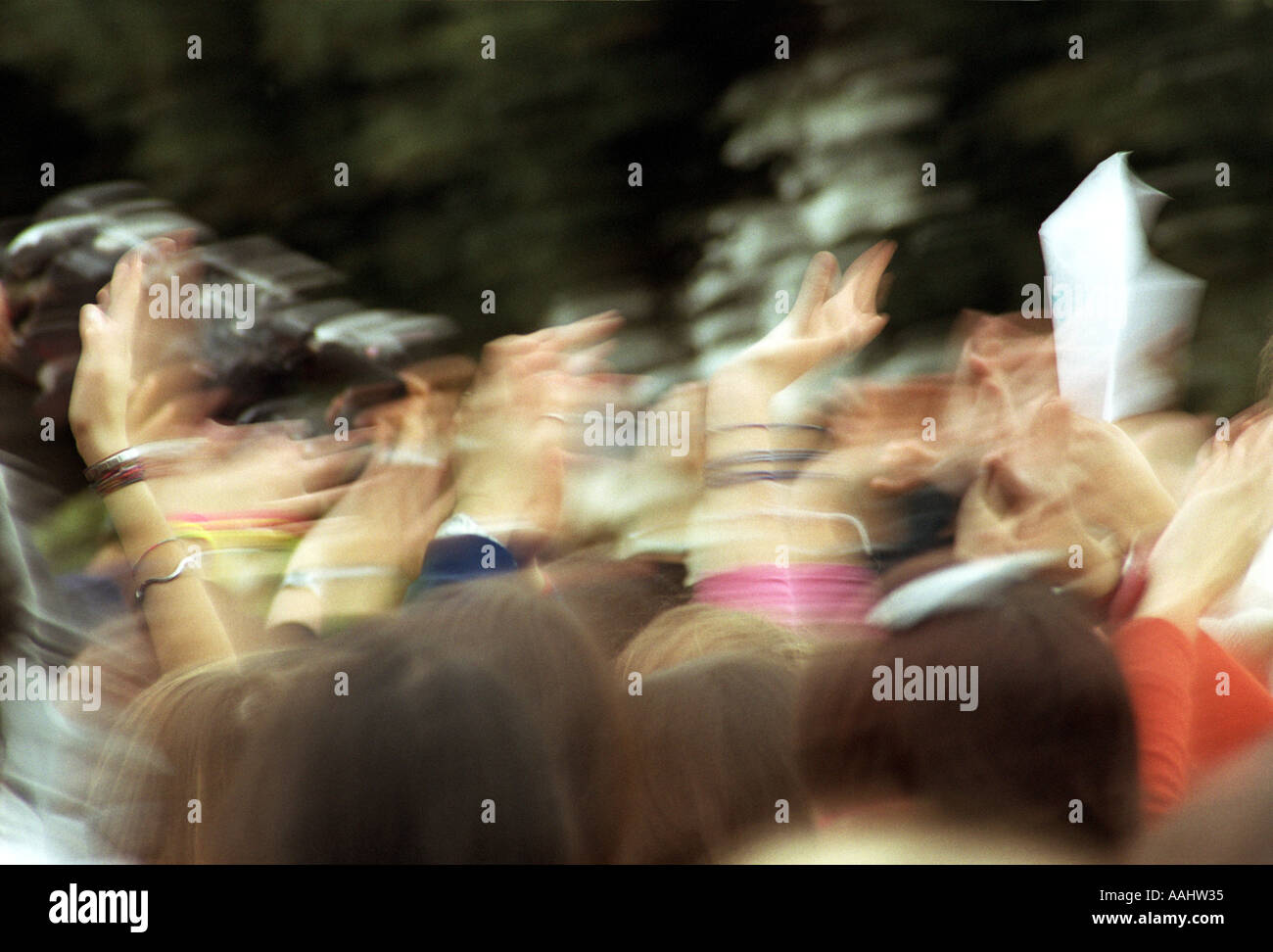 crowd with hands waving in air at concert blurred Stock Photo - Alamy