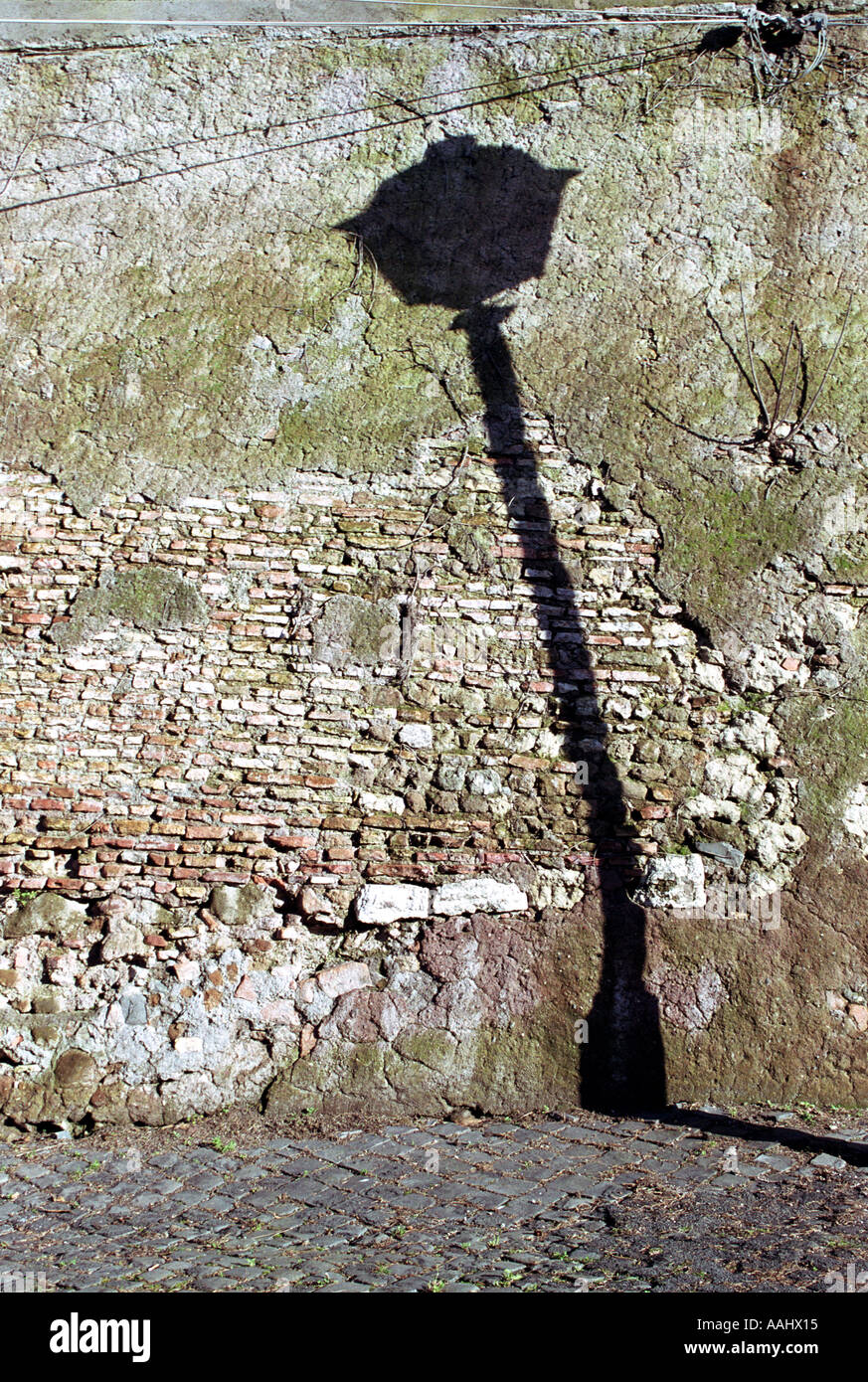leaning lamp post shadow on wall in rome Stock Photo - Alamy