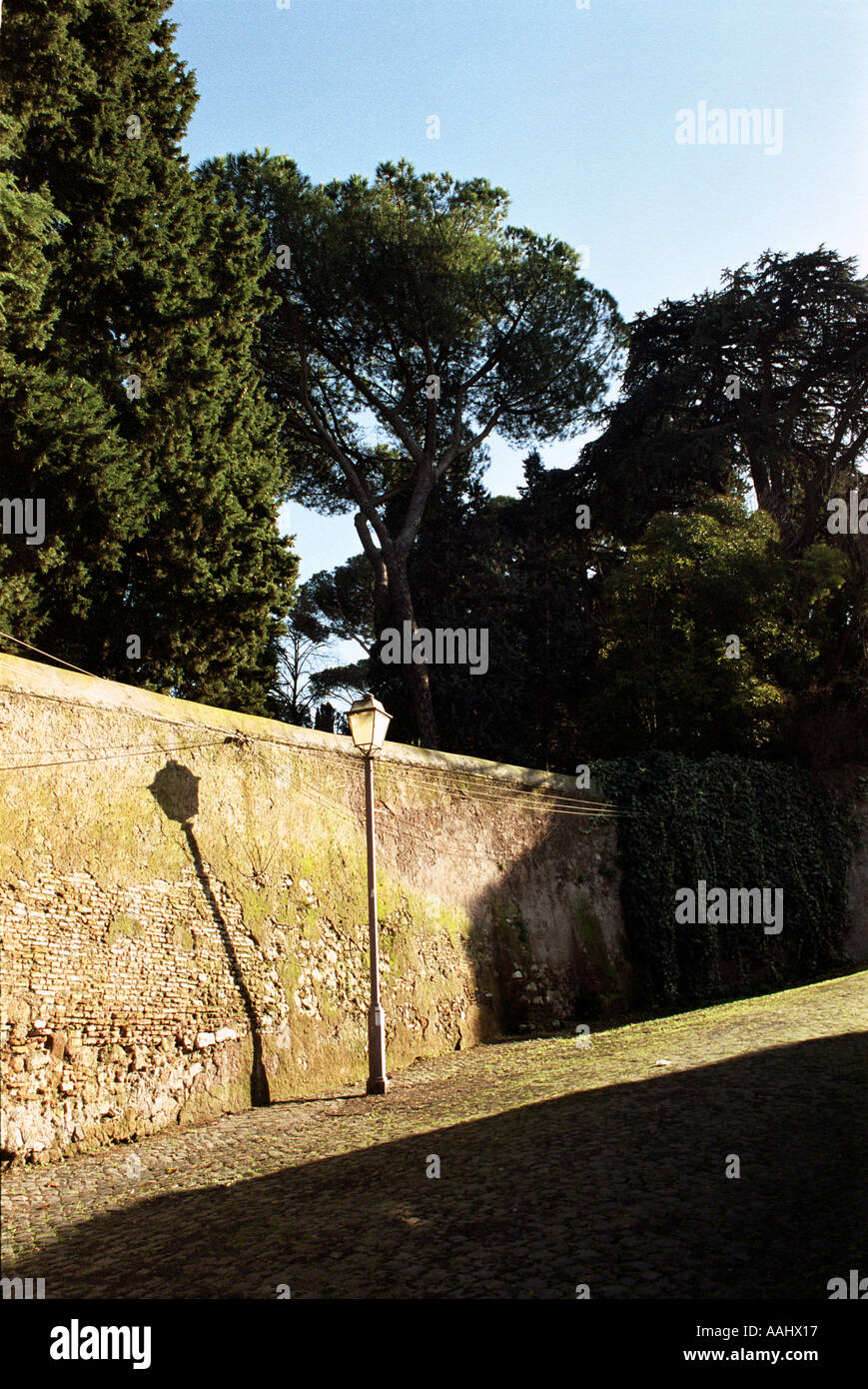 leaning lamp post with shadow on wall in rome Stock Photo - Alamy