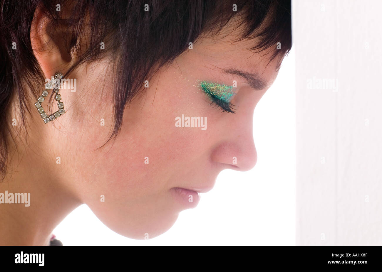 horizontal sad young woman expressing anxiety leaning against wall ...
