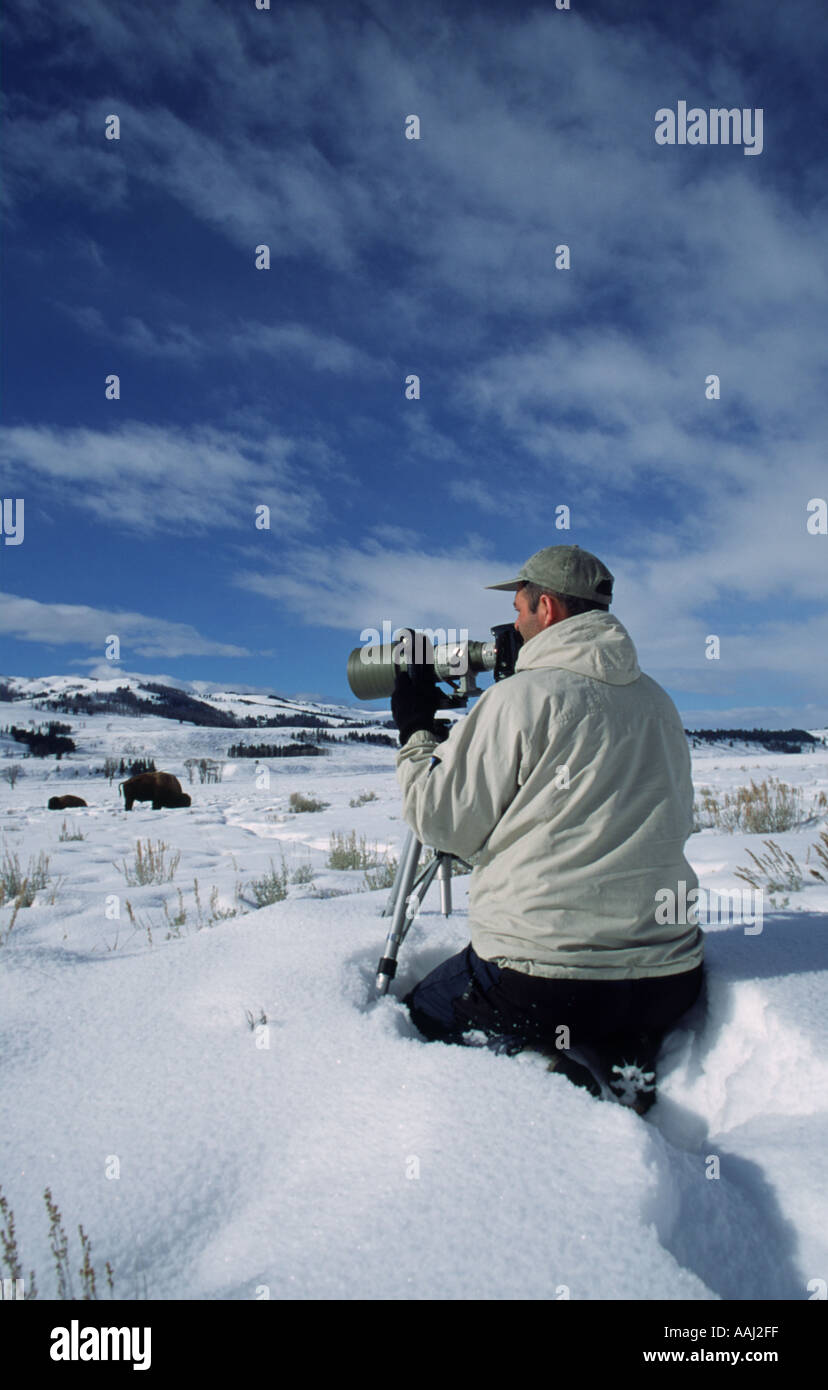 Photographer using a big lens Stock Photo - Alamy